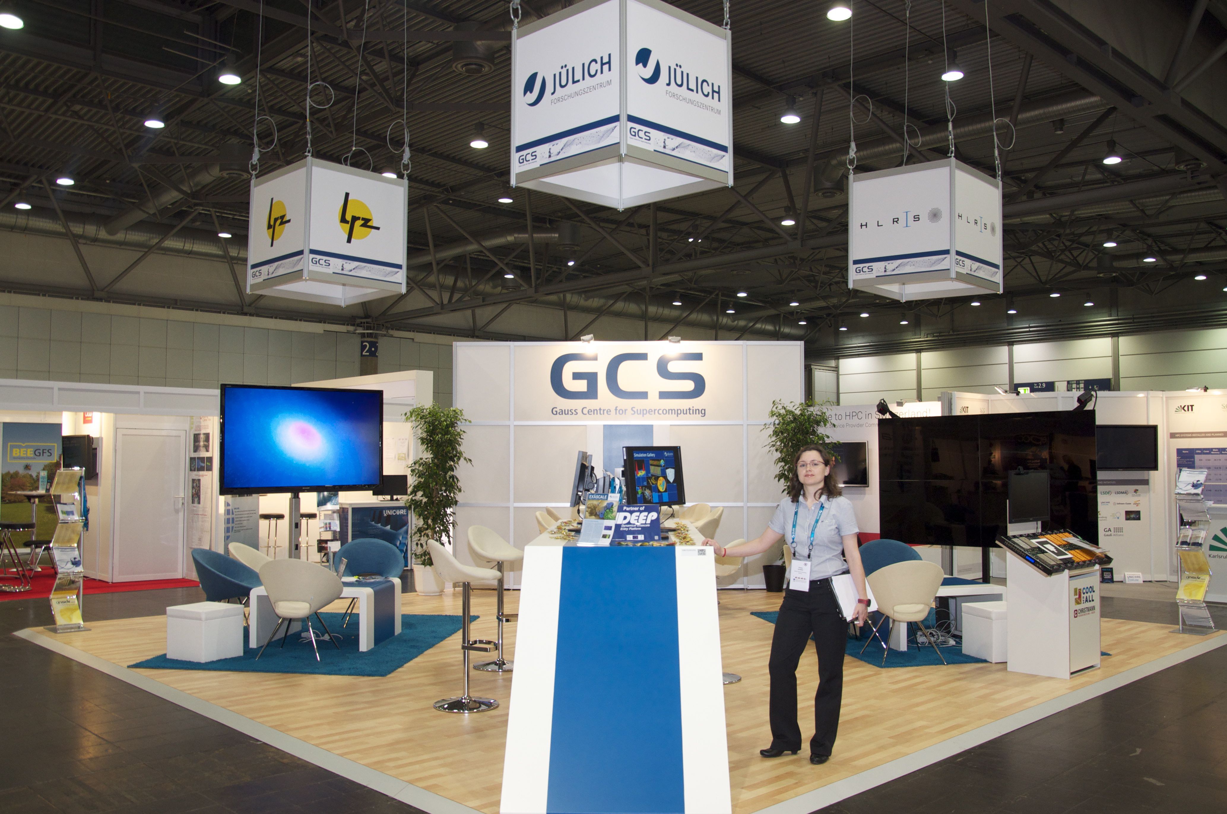 GCS booth with JSC counter in front; Estela Suarez (JSC).
